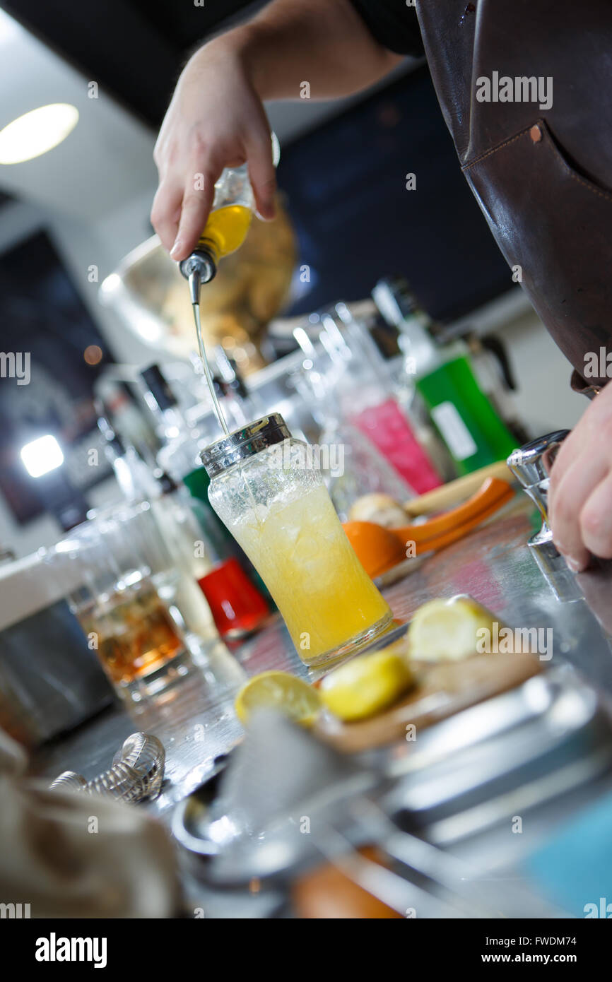 Bartender is straining cocktail in a glass Stock Photo - Alamy