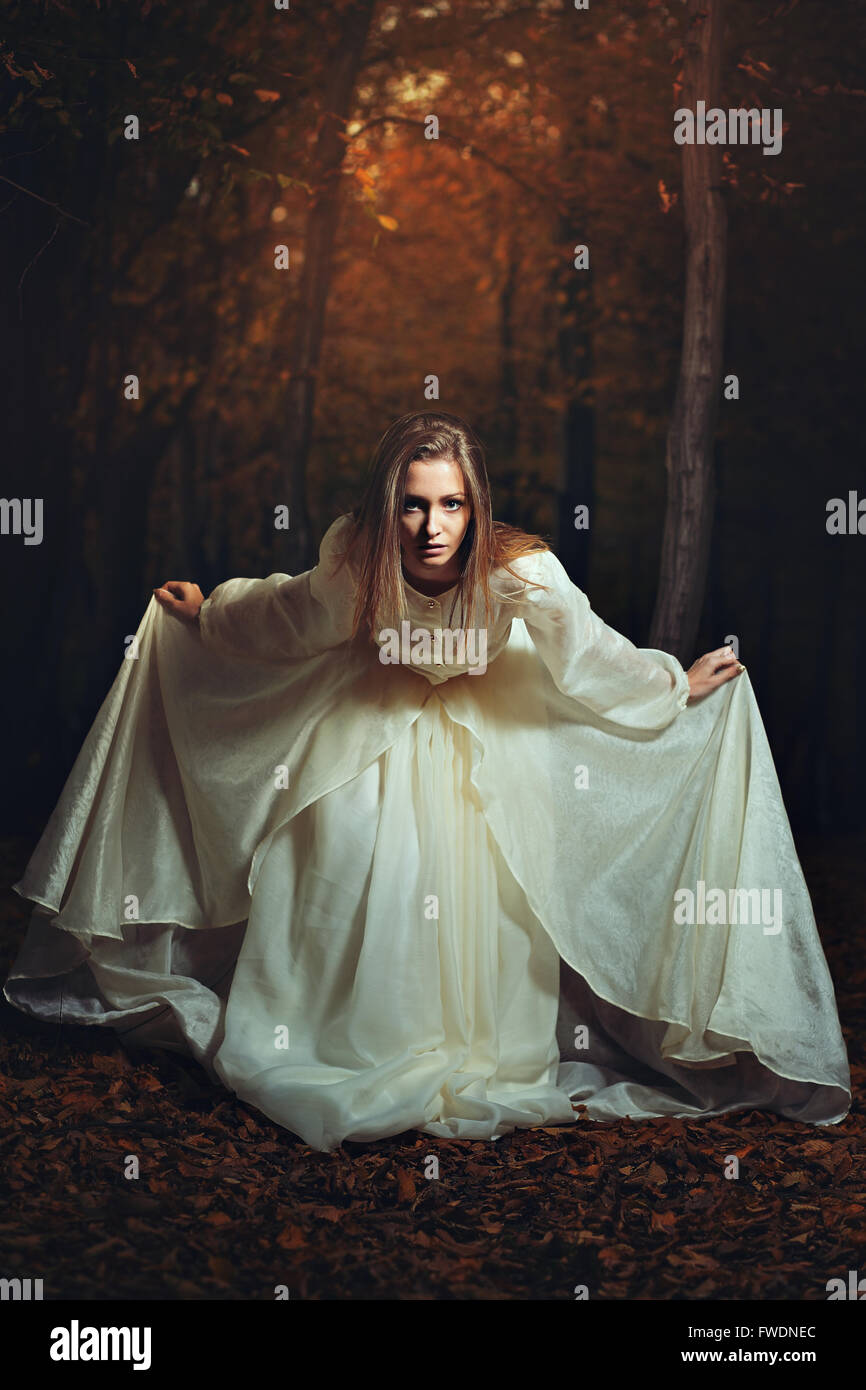 Beautiful woman bowing in colorful woods . Surreal and fantasy Stock ...