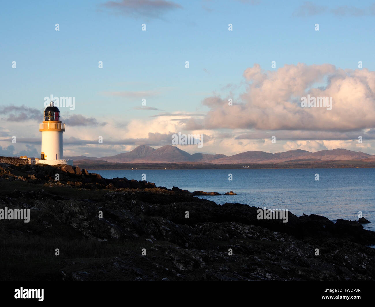 Evening light on lighthouse, Port Ellen, Islay, Scotland with Paps of ...