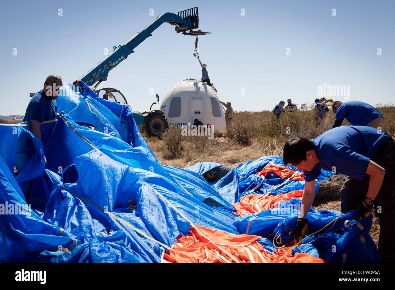 Members of the Blue Origin team recover the New Shepard space capsule ...