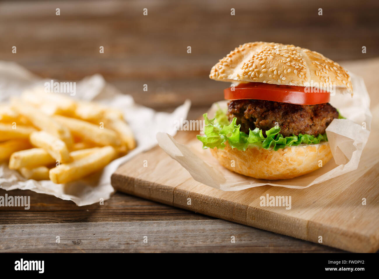 Homemade hamburgers and french fries on wooden table Stock Photo - Alamy