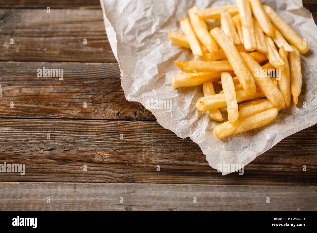 French fries on wooden table Stock Photo - Alamy