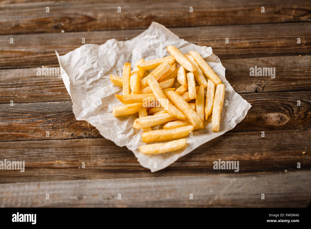 French fries on wooden table Stock Photo - Alamy
