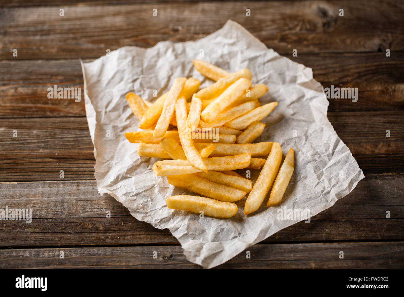 French fries on wooden table Stock Photo - Alamy