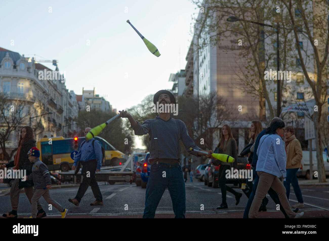 Street performer entertaining drivers at a traffic light in Lisbon ...