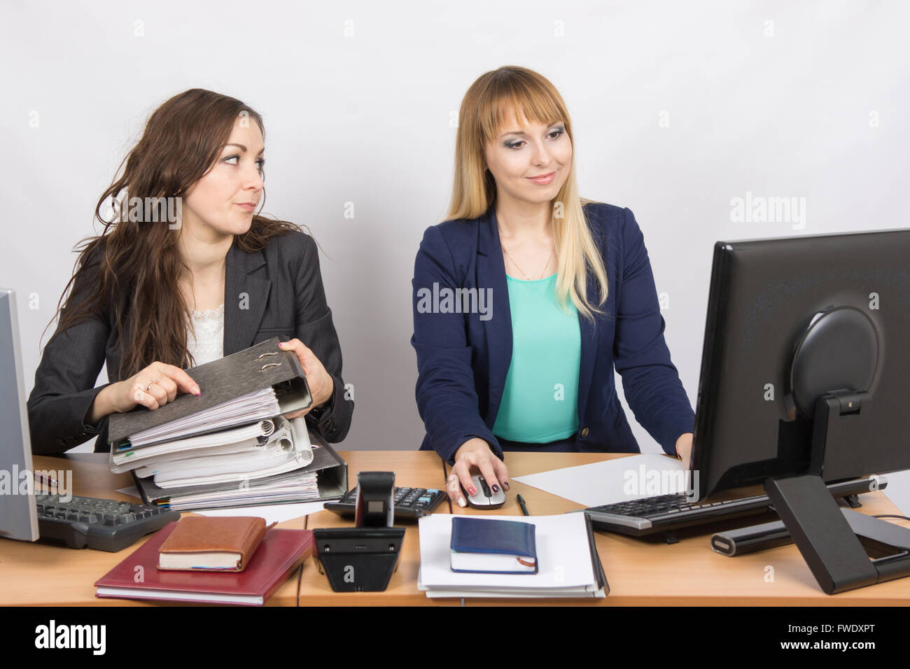 Office employee asks for help from colleagues at work with papers and ...