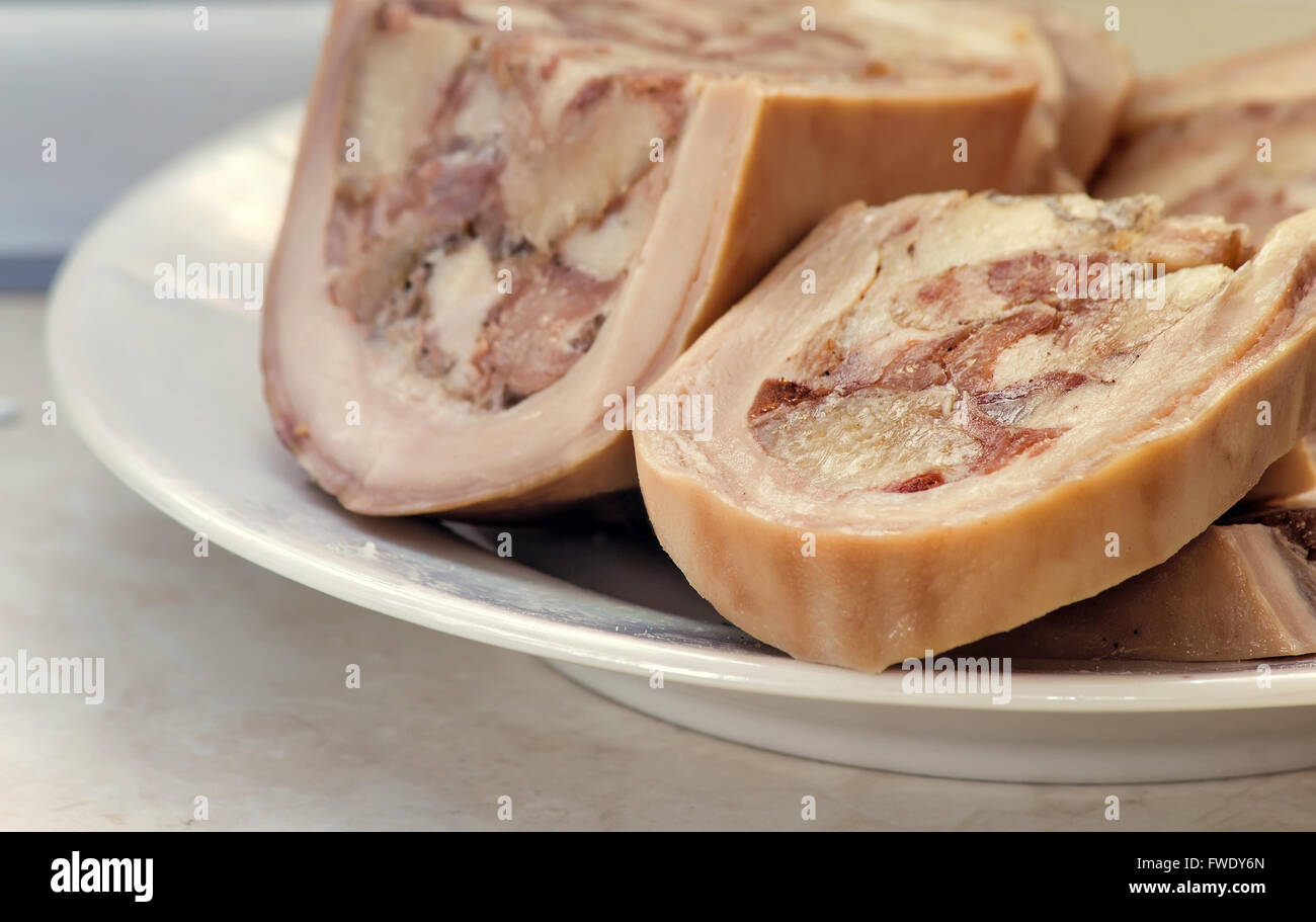 On the kitchen blackboard is sliced pig's stomach, stuffed with meat ...