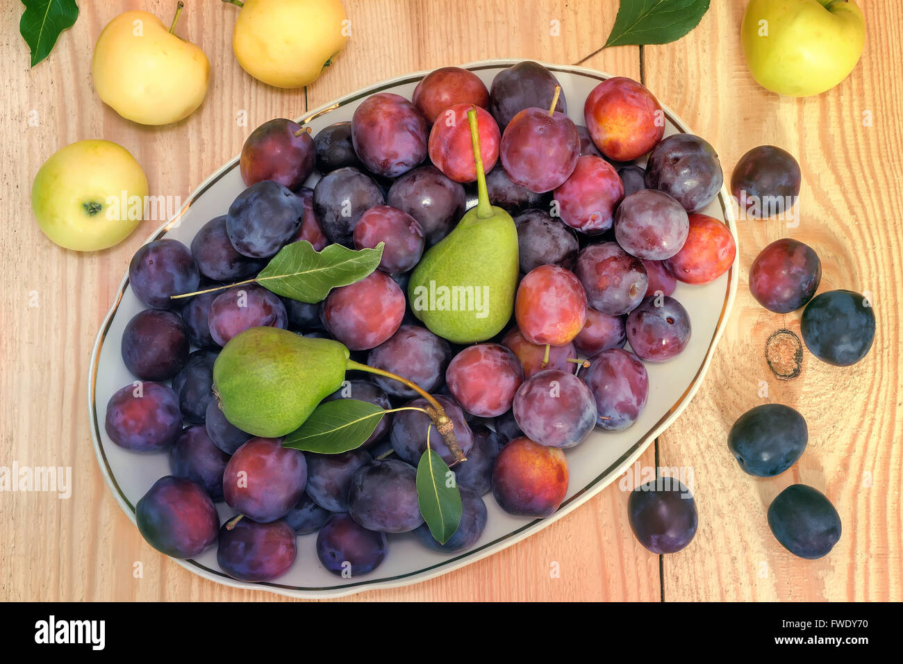 On the surface of the wooden table is a ceramic dish filled with large ...