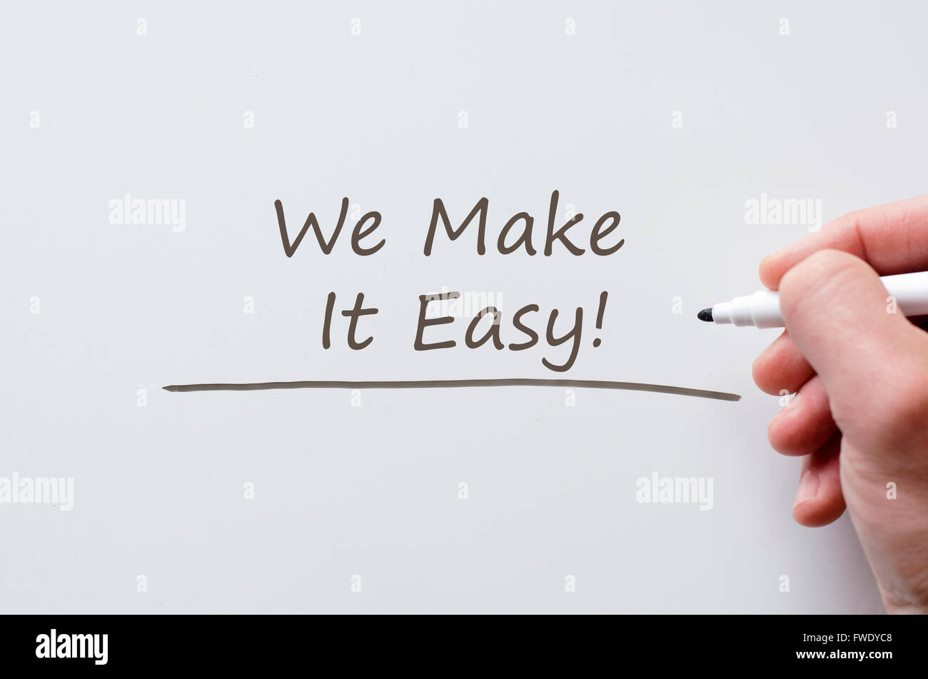 Human hand writing we make it easy on whiteboard Stock Photo - Alamy