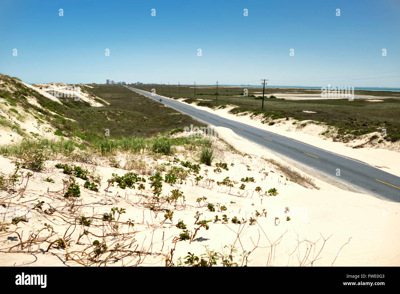 Texas Highway 100 with the skyline of the city of South Padre Island in ...