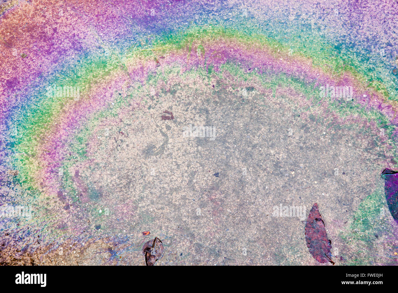 Oil on ground when wet cause rainbow on water on ground concrete Stock ...