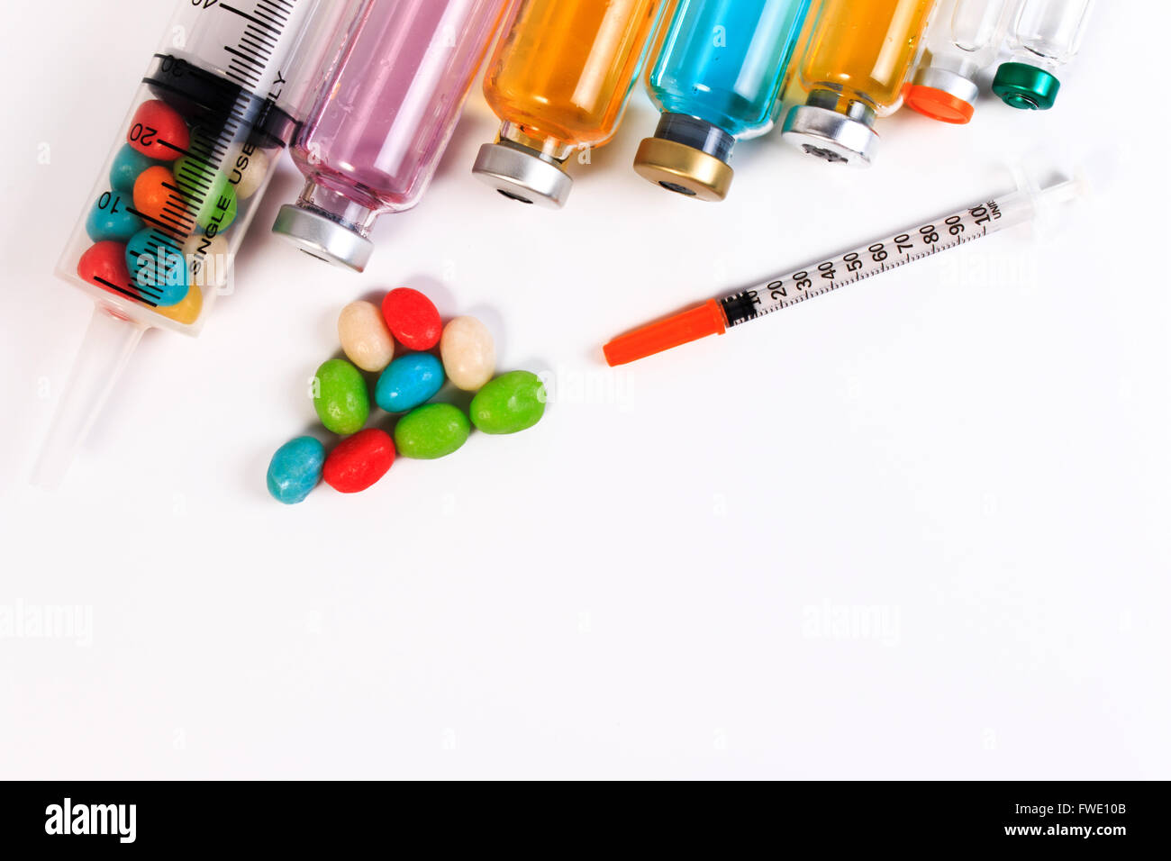 A syringe and candy bottle isolate on white background. Protect against ...