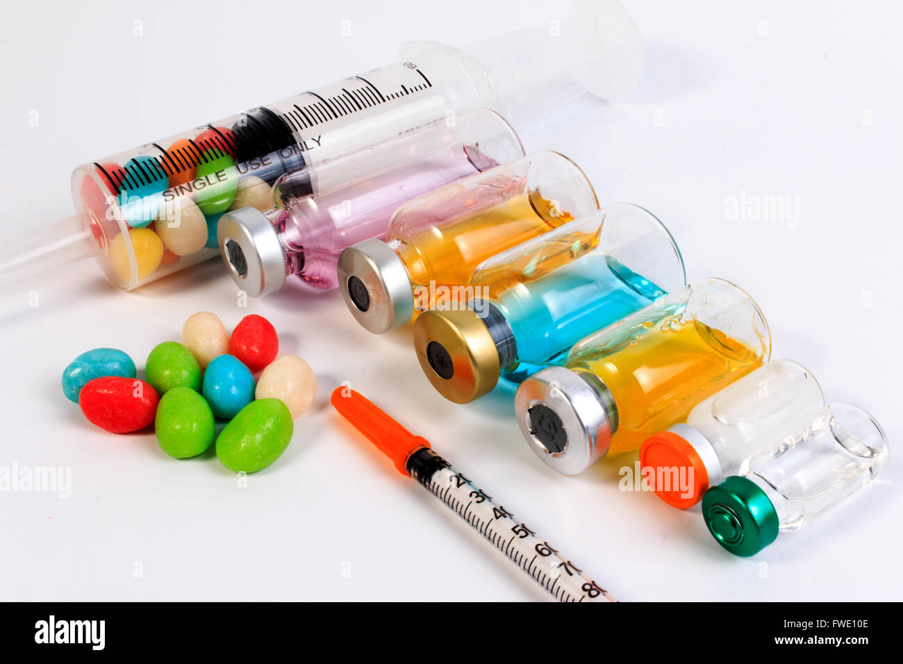 A syringe and candy bottle isolate on white background. Protect against ...