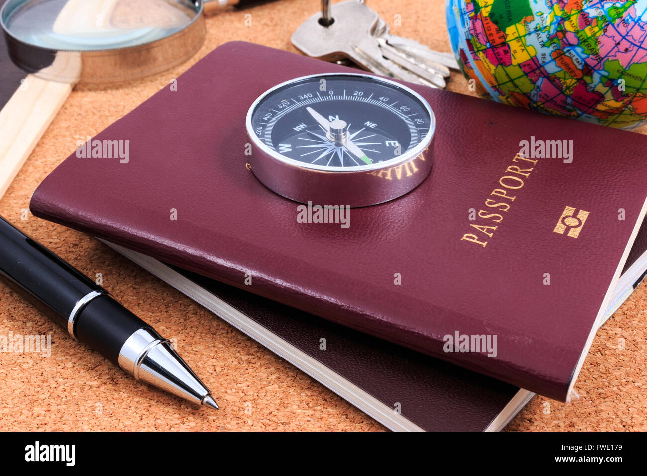 Preparation for travel, compass, passport, pen, magnifier and ...