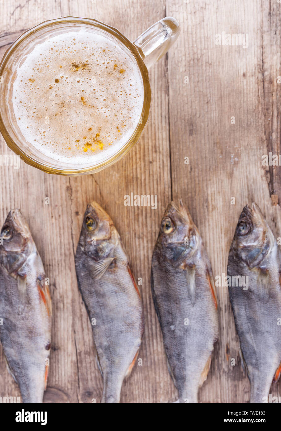 dried fish with beer on the table top view background Stock Photo - Alamy