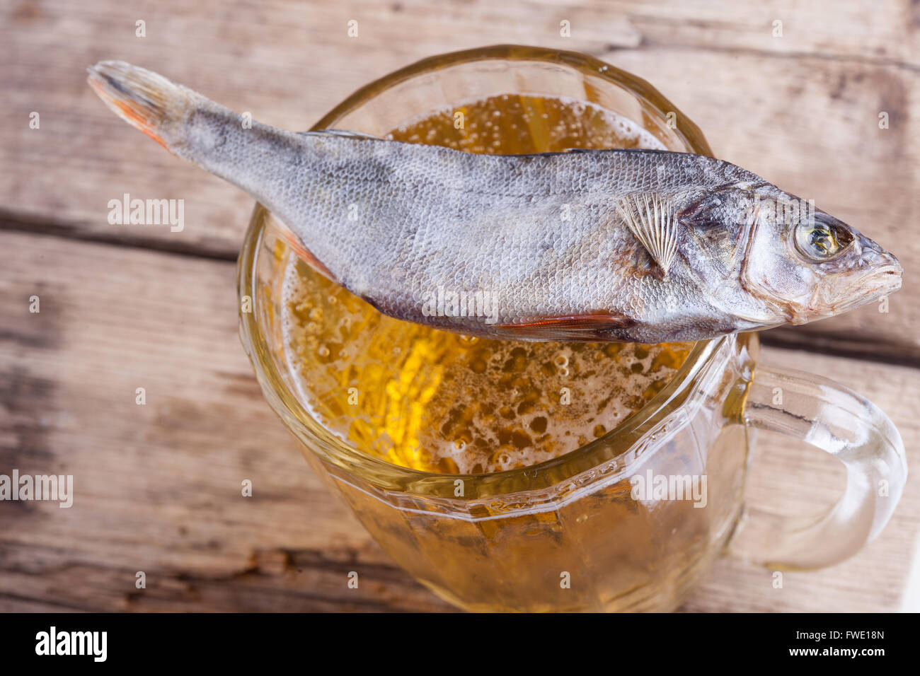 dried fish with beer on the table background Stock Photo - Alamy