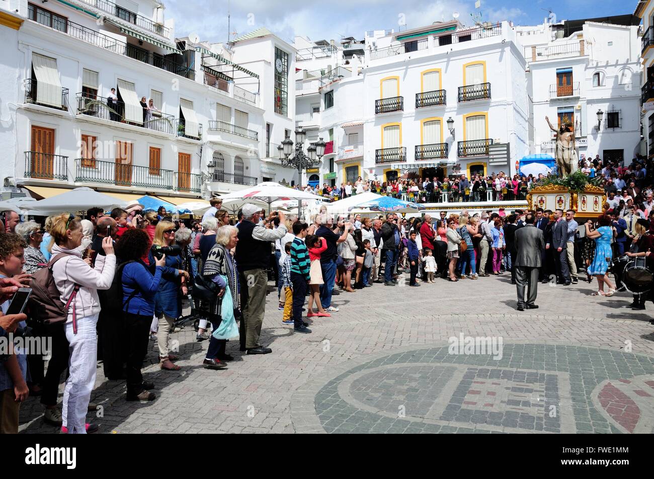 Easter procession arriving at the crowded Plaza of Competa Village ...
