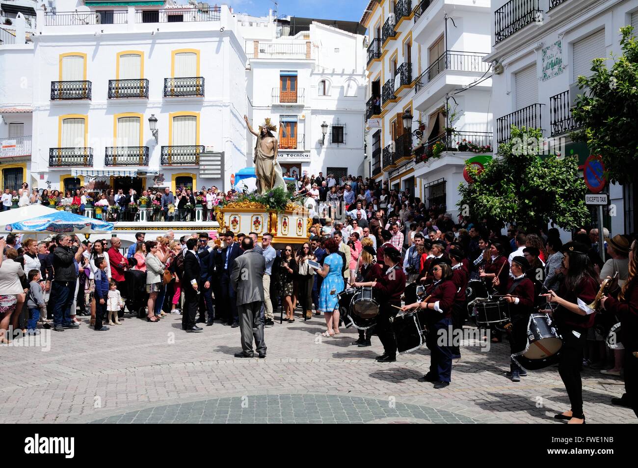 Easter procession arriving at the crowded Plaza of Competa Village ...