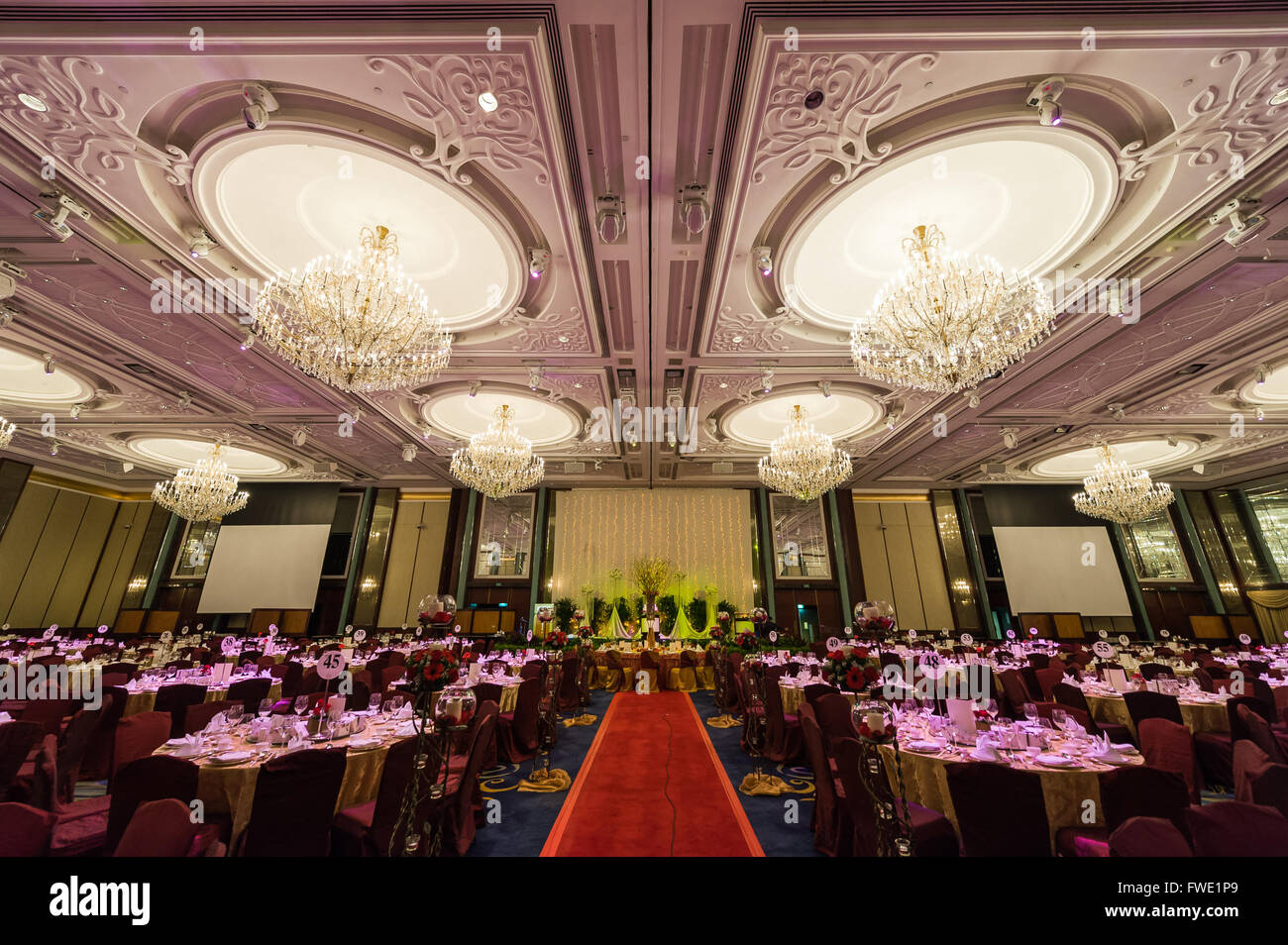 Grand restaurant interior with chandeliers and table setups Stock Photo ...