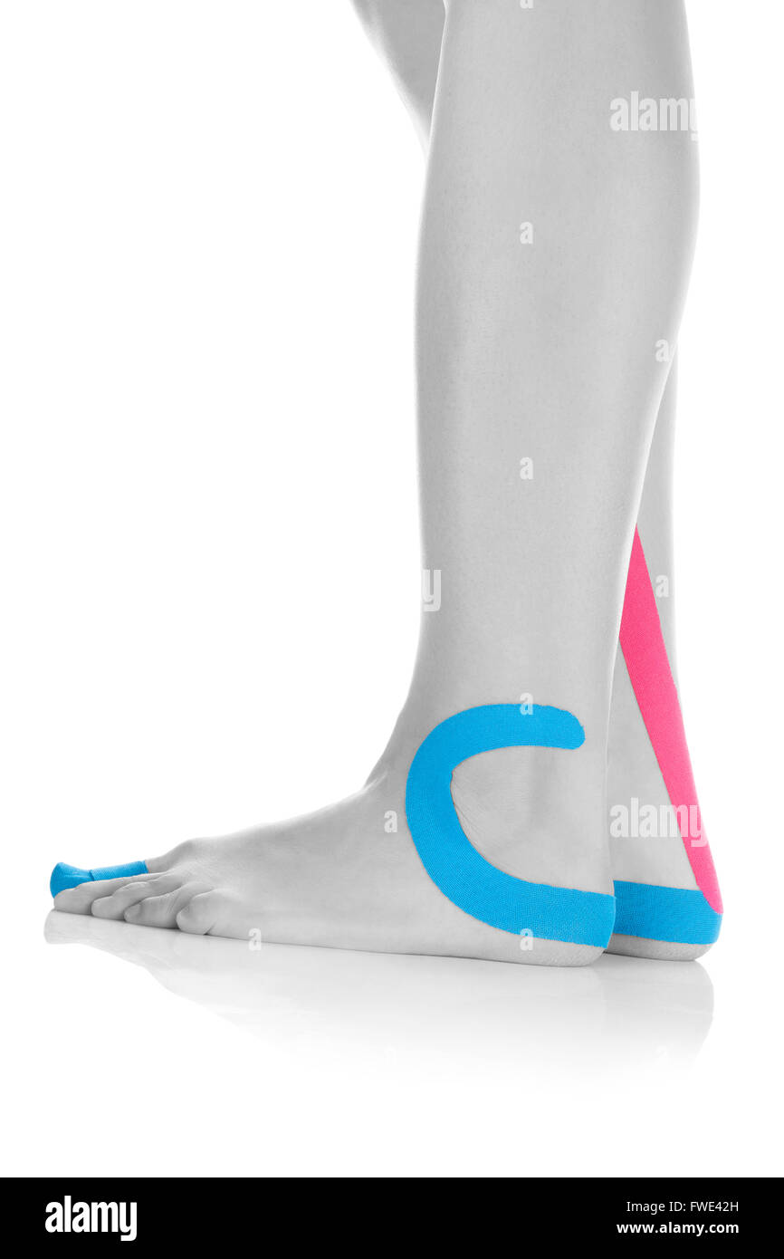 Therapeutic tape on female leg isolated on white background. Chronic ...