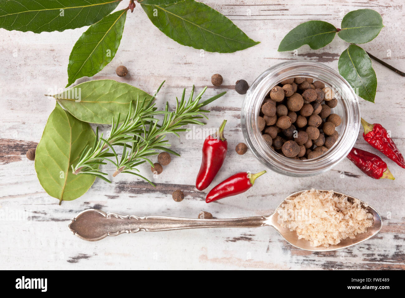 Bay leaves, traditional spice and condiment on white wooden background ...