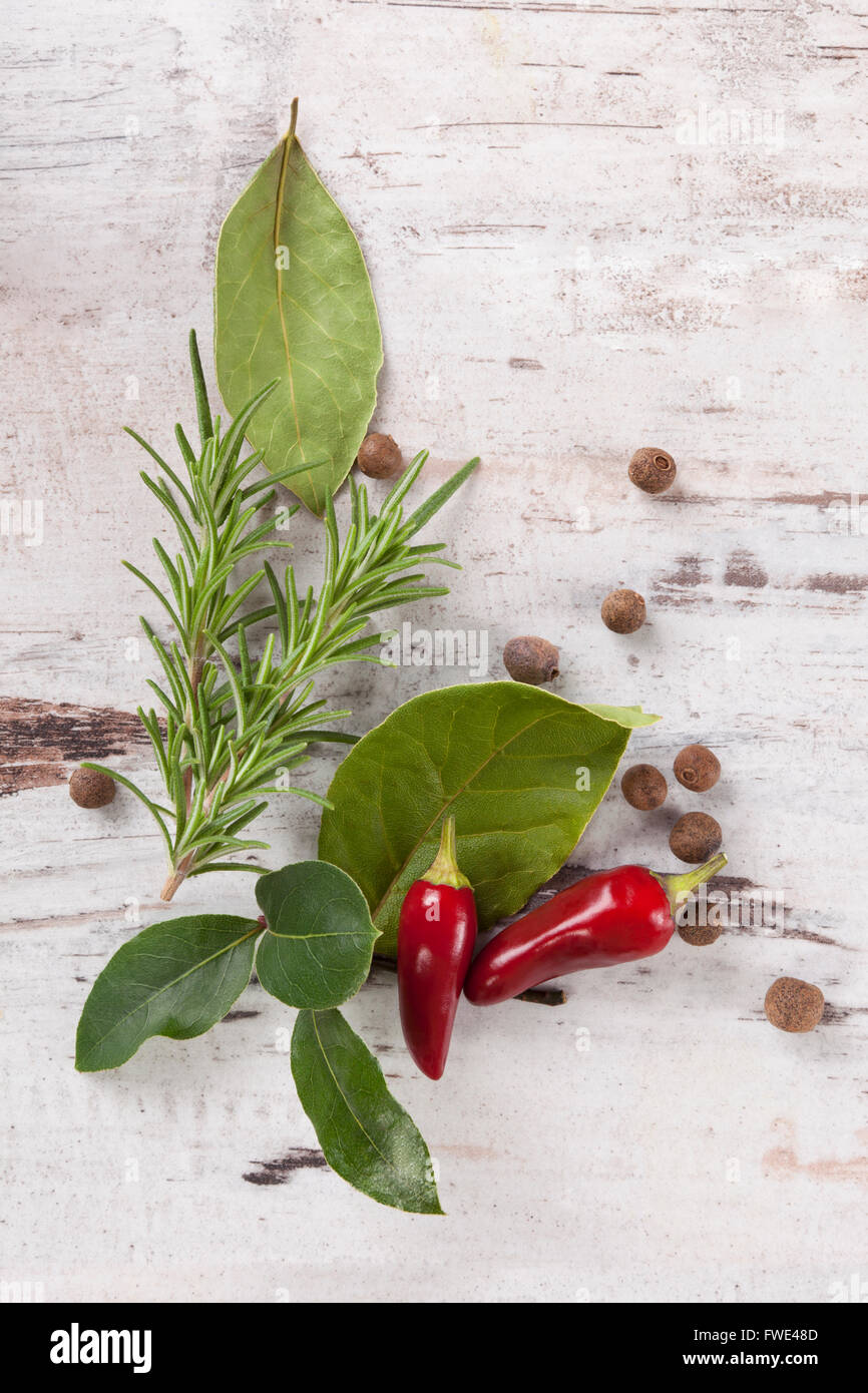 Bay leaves, traditional spice and condiment on white wooden background ...
