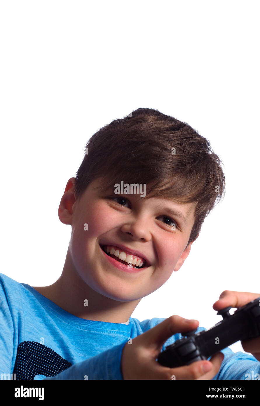 Happy young boy playing video games, Studio shot on white background ...