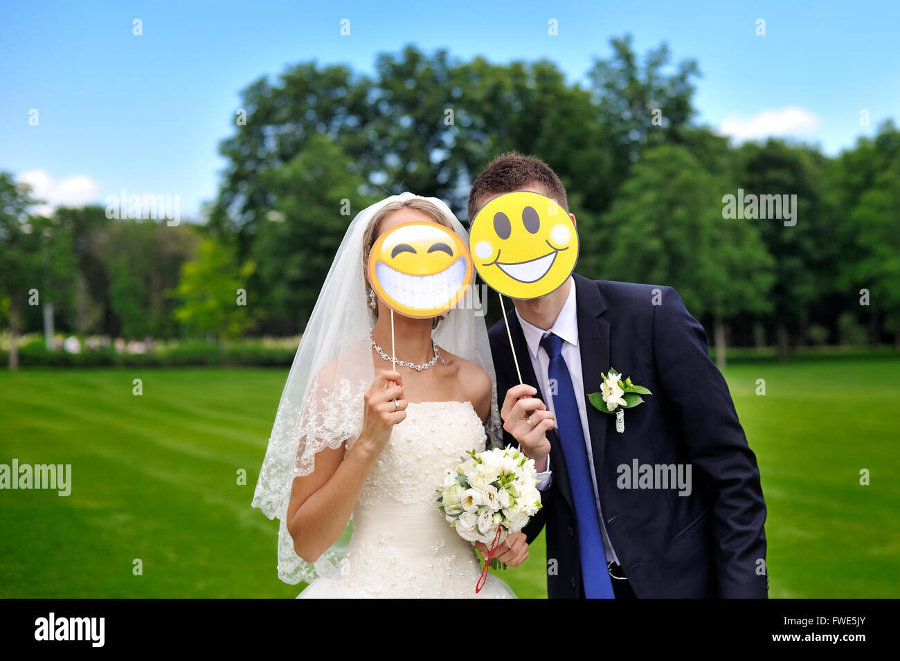 bride and groom with paper smileys Stock Photo - Alamy