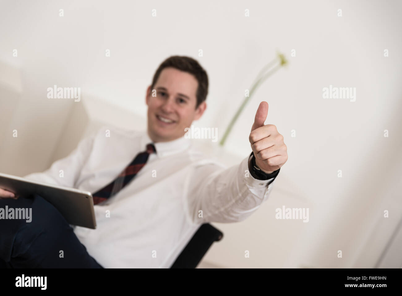 Thumbs up at the office on chair Stock Photo - Alamy