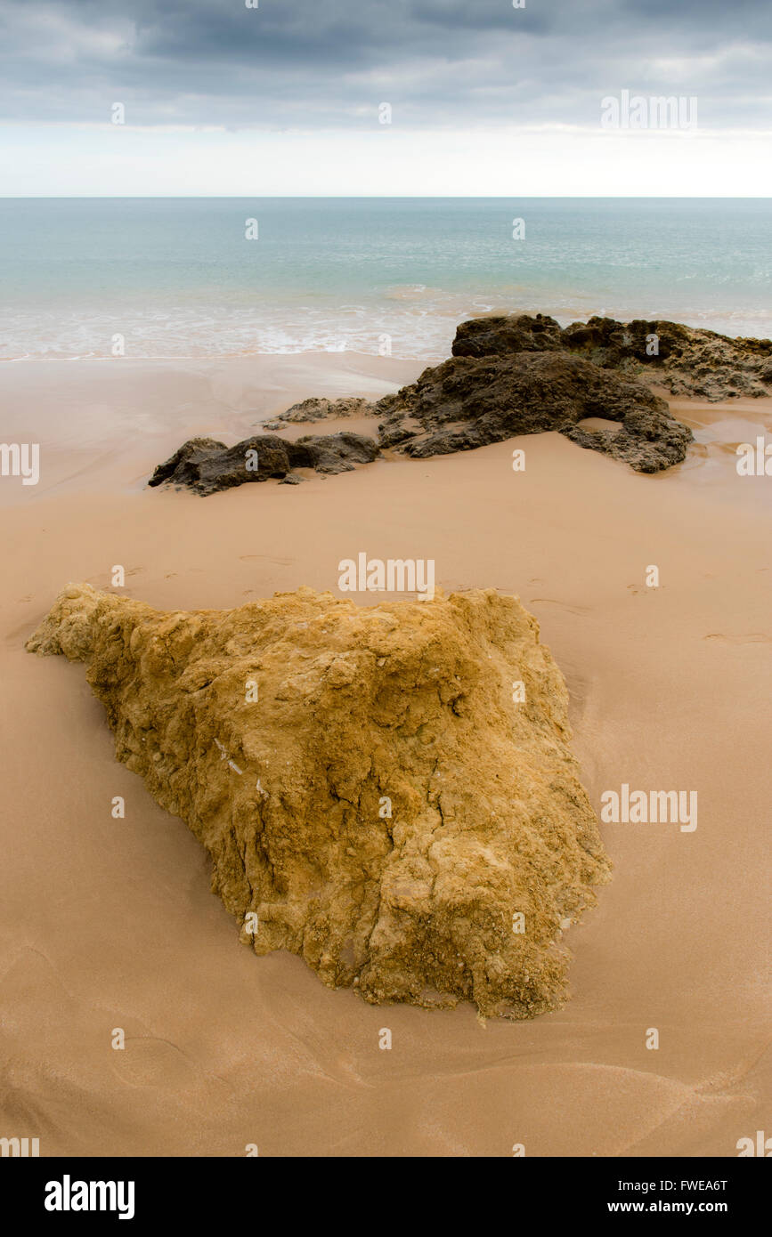 Different coloured rock outcrops on a beach near Albufeira, Algarve ...