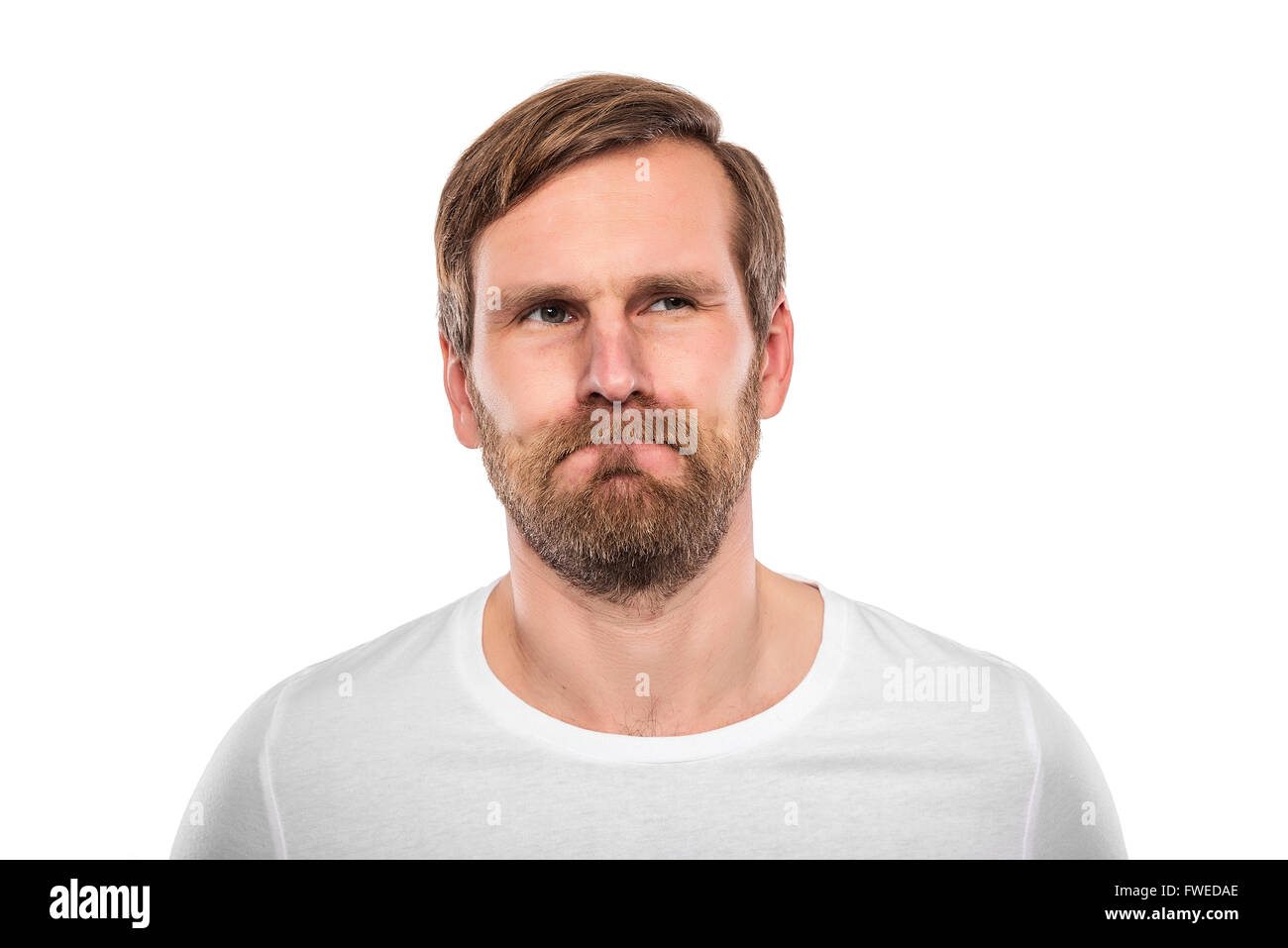 Young man in a white shirt is thinking intensely. Isolated on white ...