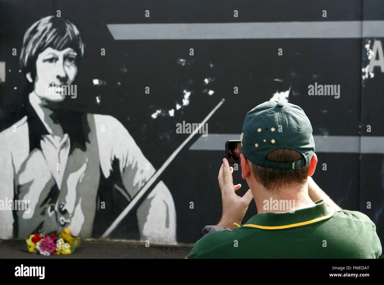 Irish Snooker star Higgins dies. A tourist photographs a mural of ...