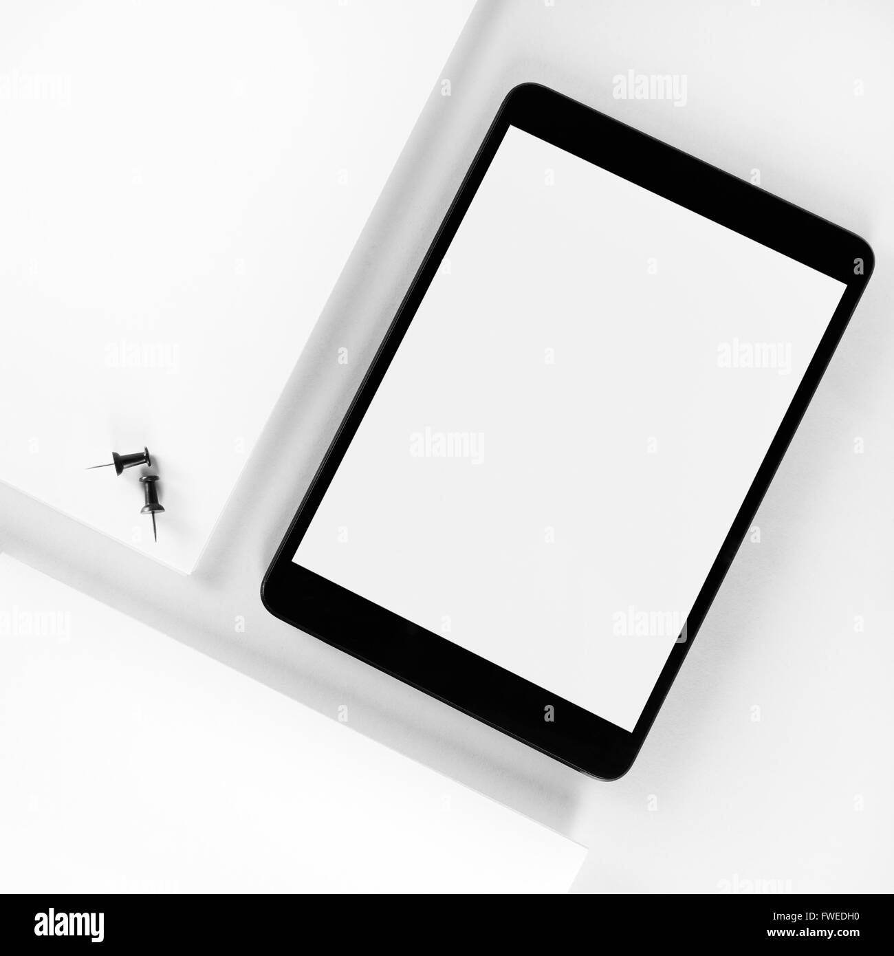 Blank tablet pc on white paper background. Mockup for design ...