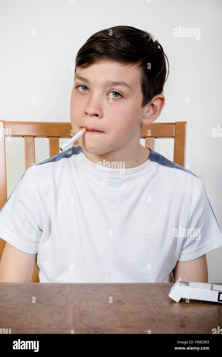 Young boy with cigarette in his mouth Stock Photo - Alamy