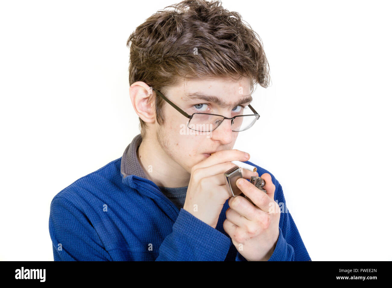 Teenage boy lighting a cigarette Stock Photo - Alamy