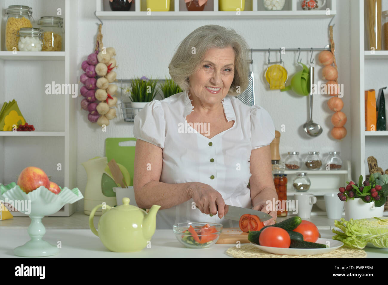Senior woman cooking in kitchen Stock Photo - Alamy