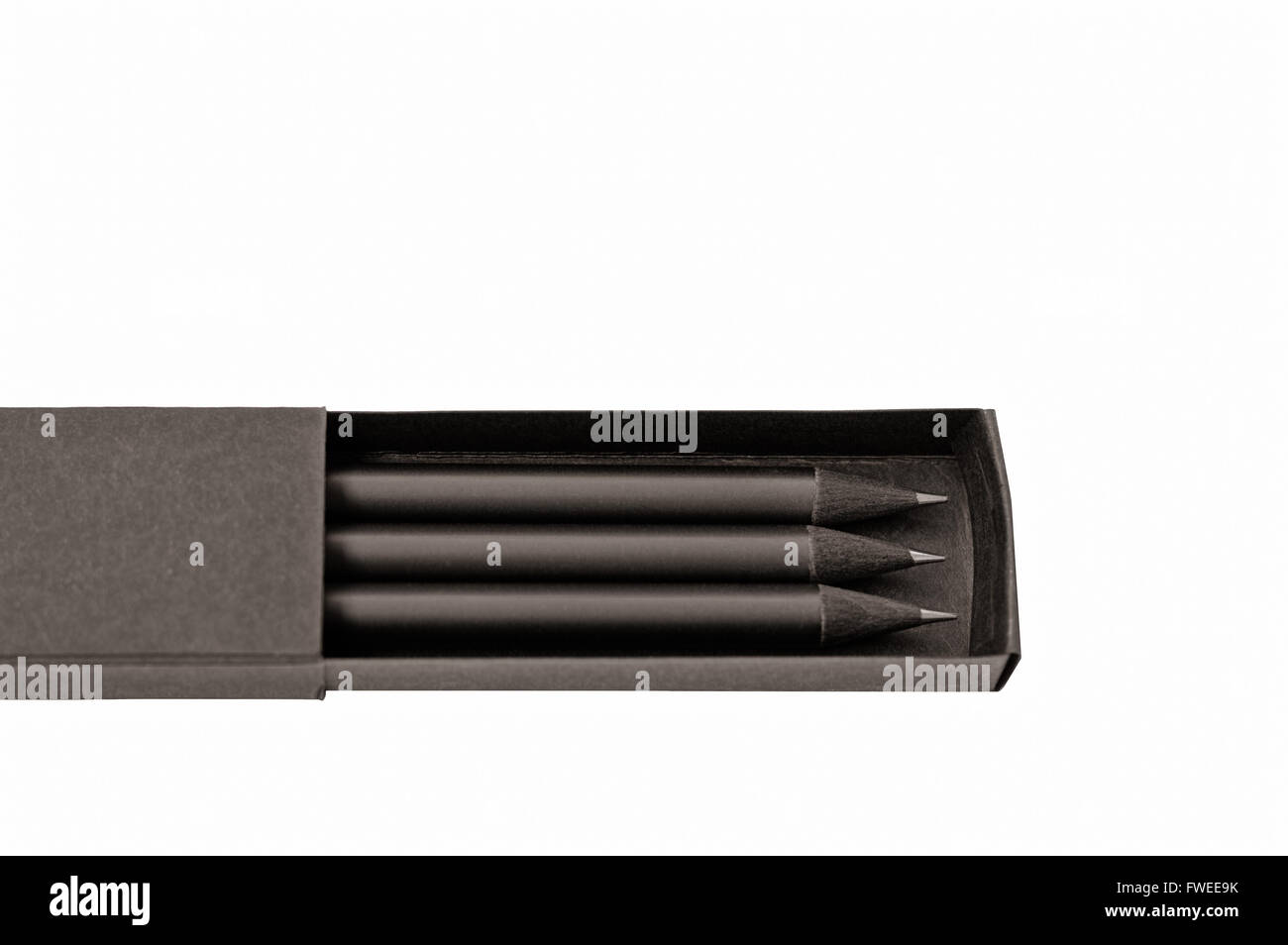 Open black cardboard box with three black pencils inside Stock Photo ...