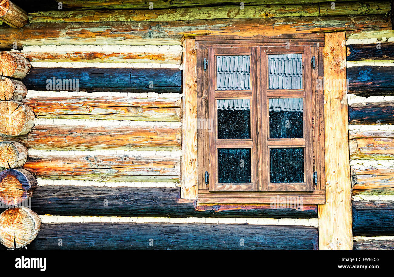 Dirty window of an old log cabin with different colored beams Stock ...