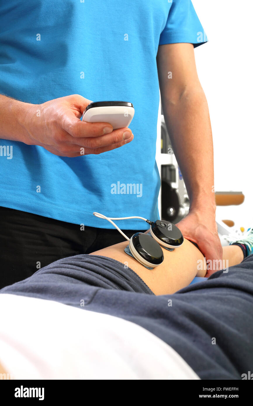 Physiotherapist doctor performs surgery on a patient's leg. Muscle ...