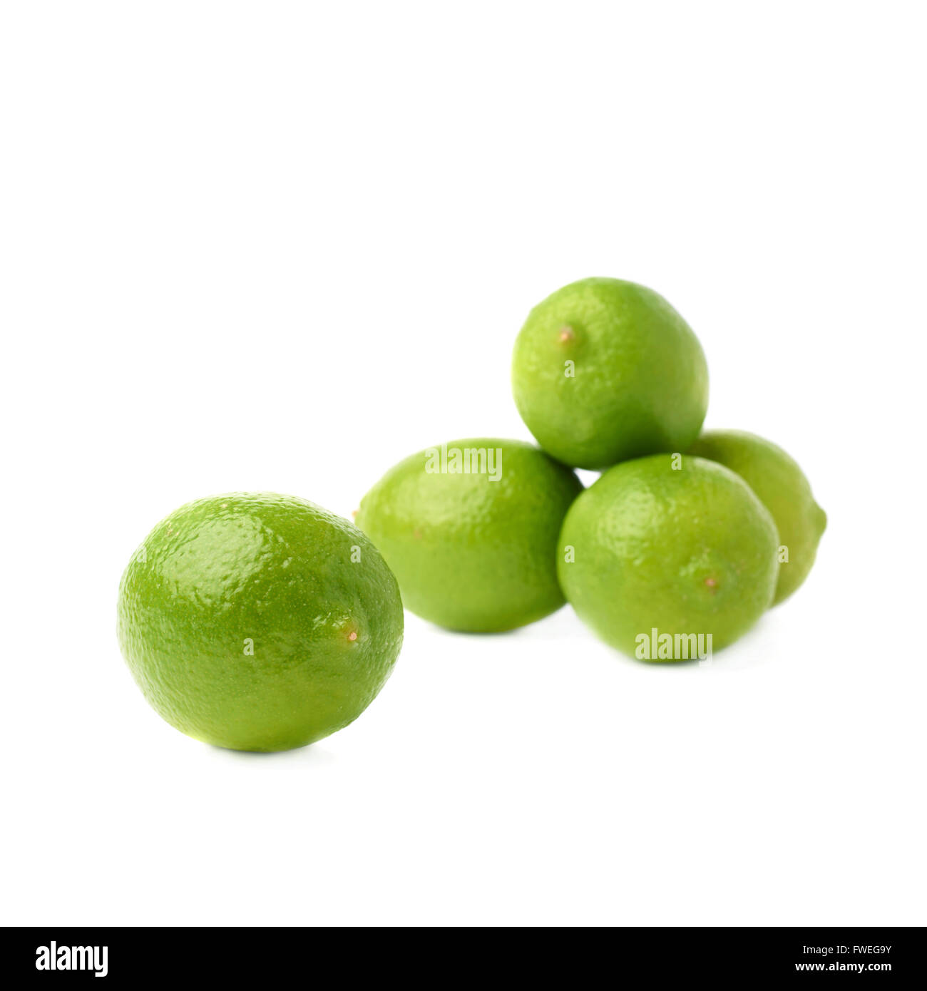 Pile of multiple ripe limes, composition isolated over the white ...