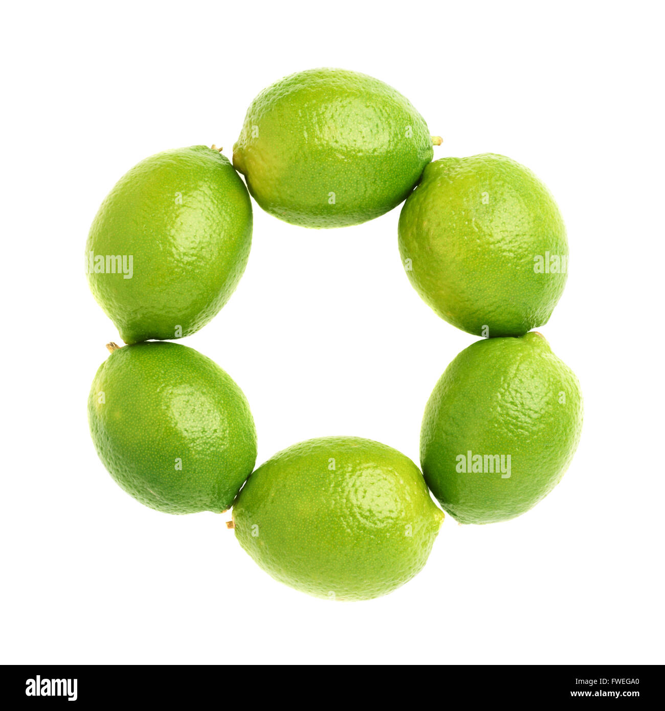 Multiple ripe limes aligned in a circle round frame, composition ...