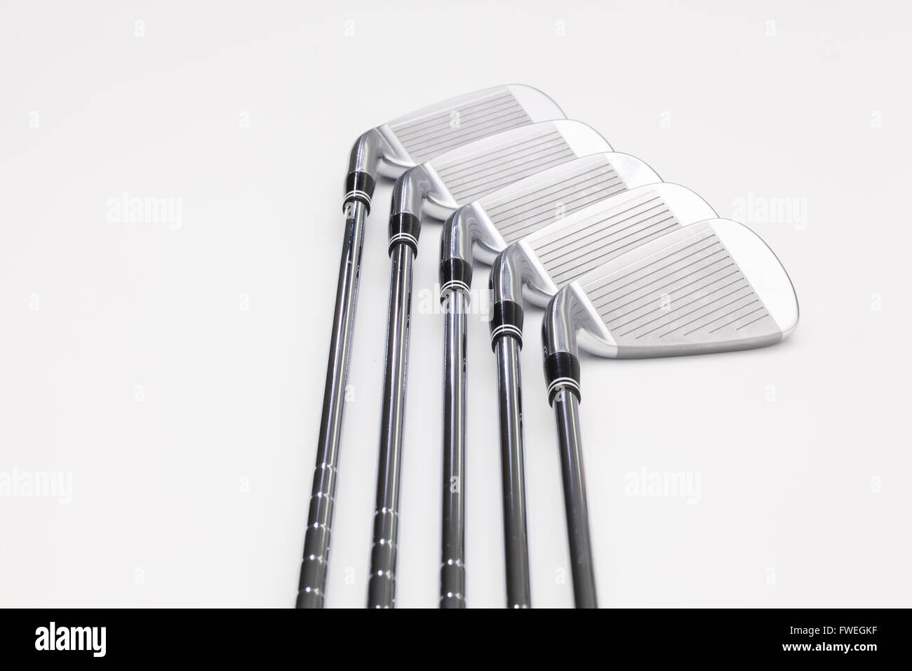 Titanium golf clubs on the white background Stock Photo - Alamy