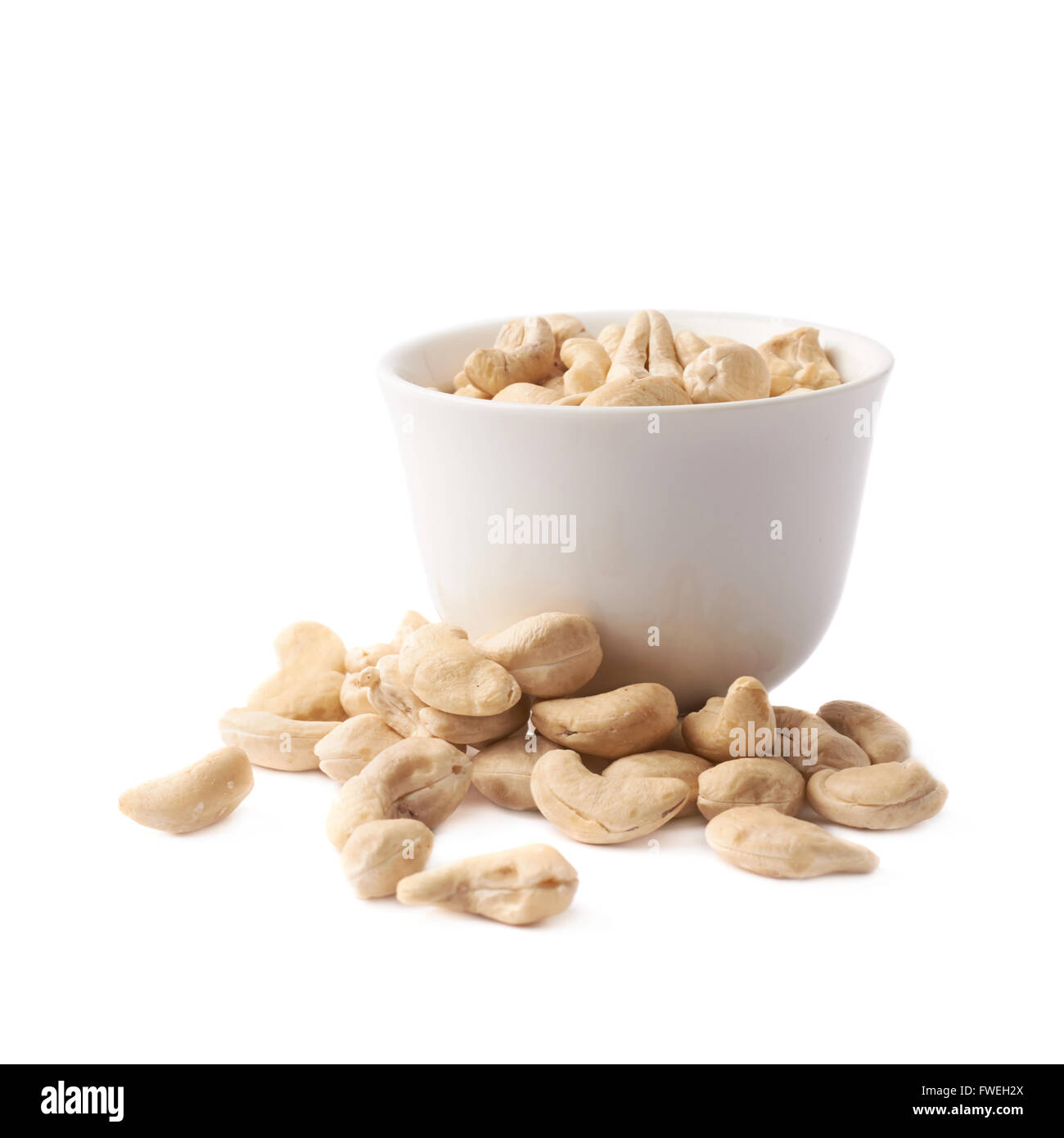 Cup filled with the cashew nuts isolated Stock Photo - Alamy