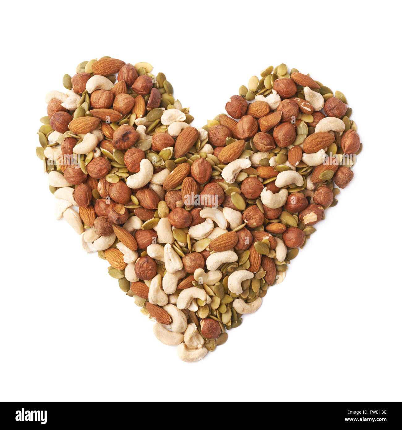 Heart shape made of nuts and seeds Stock Photo - Alamy
