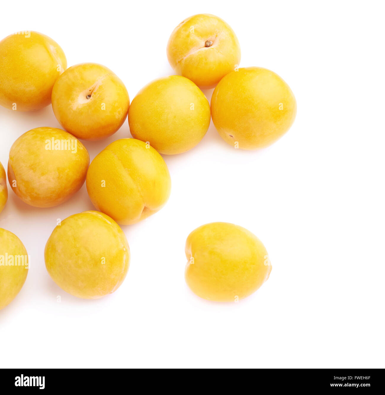 Pile of multiple yellow plums isolated Stock Photo - Alamy