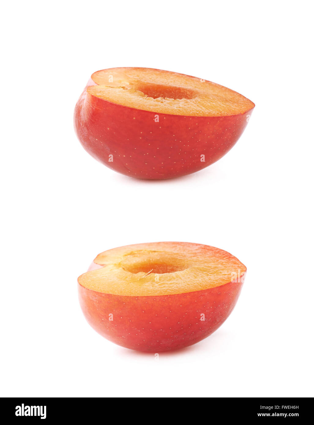 Cut open plum half isolated Stock Photo - Alamy