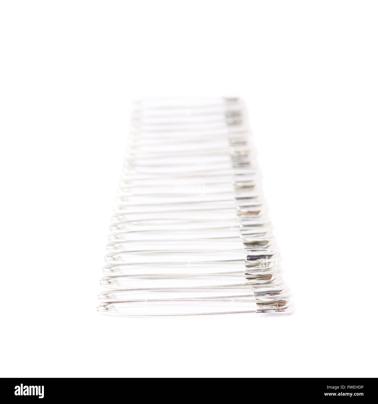 Line border made of multiple safety pins isolated on white background ...