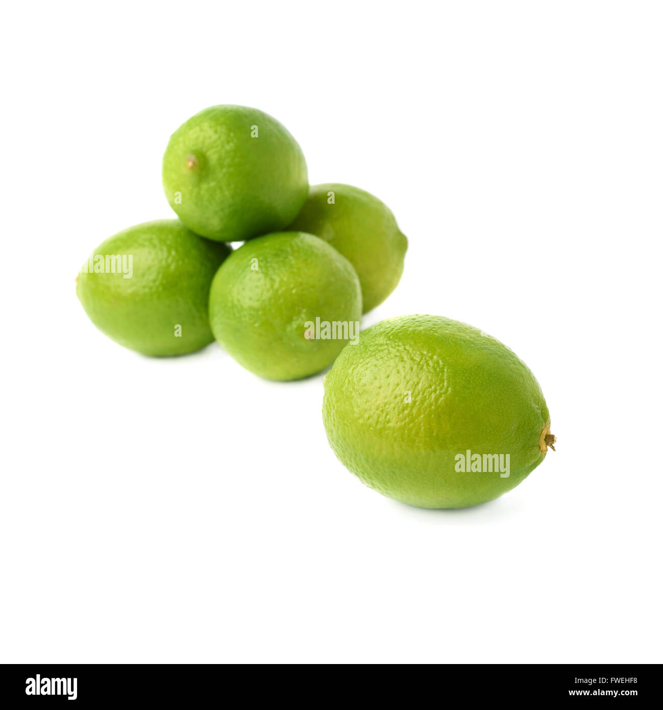 Pile of multiple ripe limes, composition isolated over the white ...
