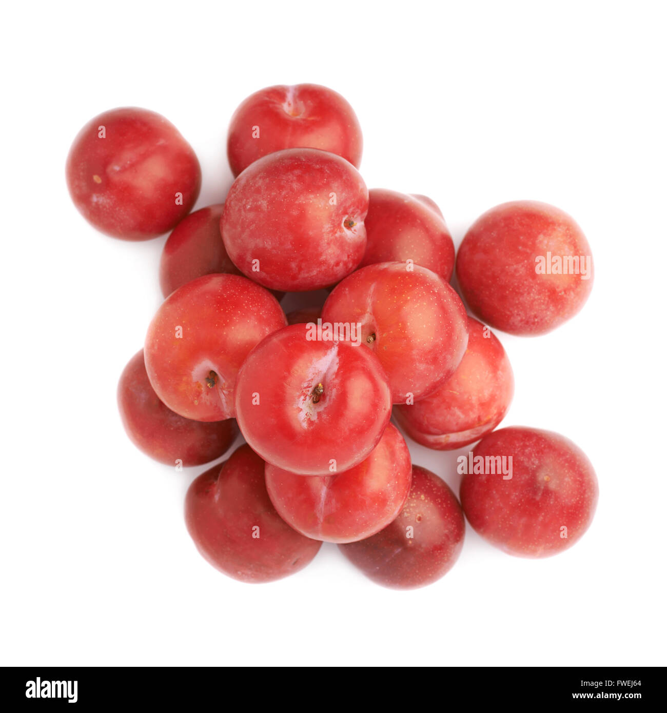 Pile of multiple red plums isolated Stock Photo - Alamy