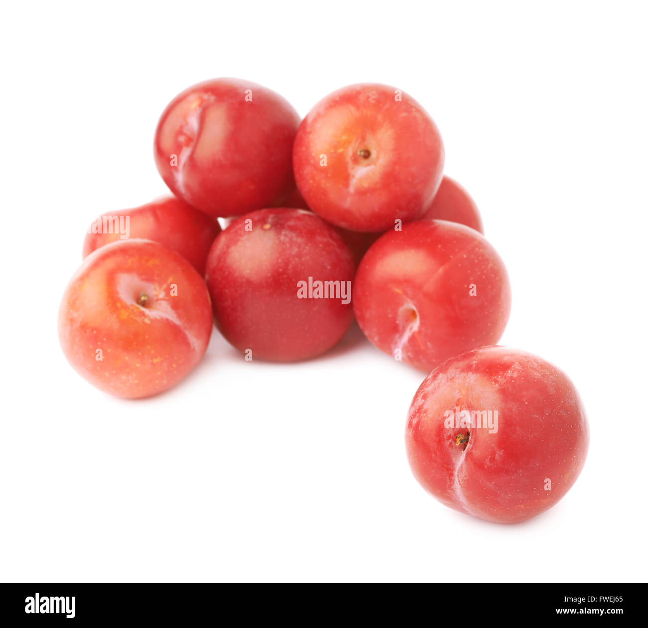 Pile of multiple red plums isolated Stock Photo - Alamy